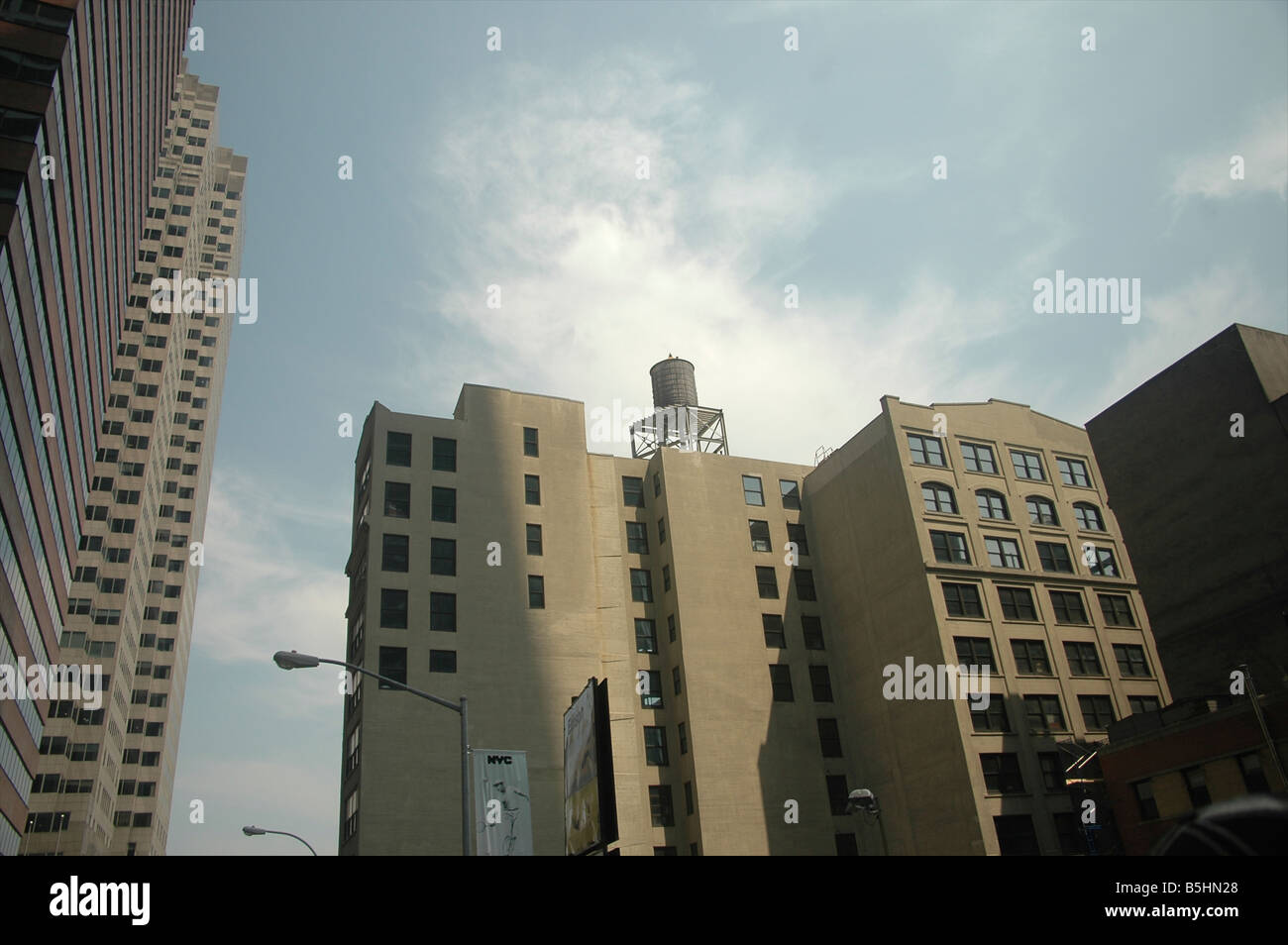 A water tower on top of sky scrapers in New York Stock Photo - Alamy