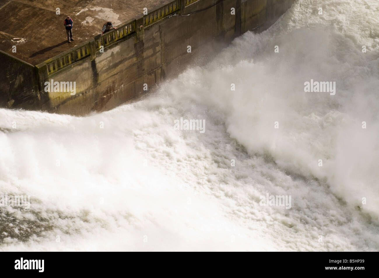 Overflow of water with man standing near by Stock Photo - Alamy