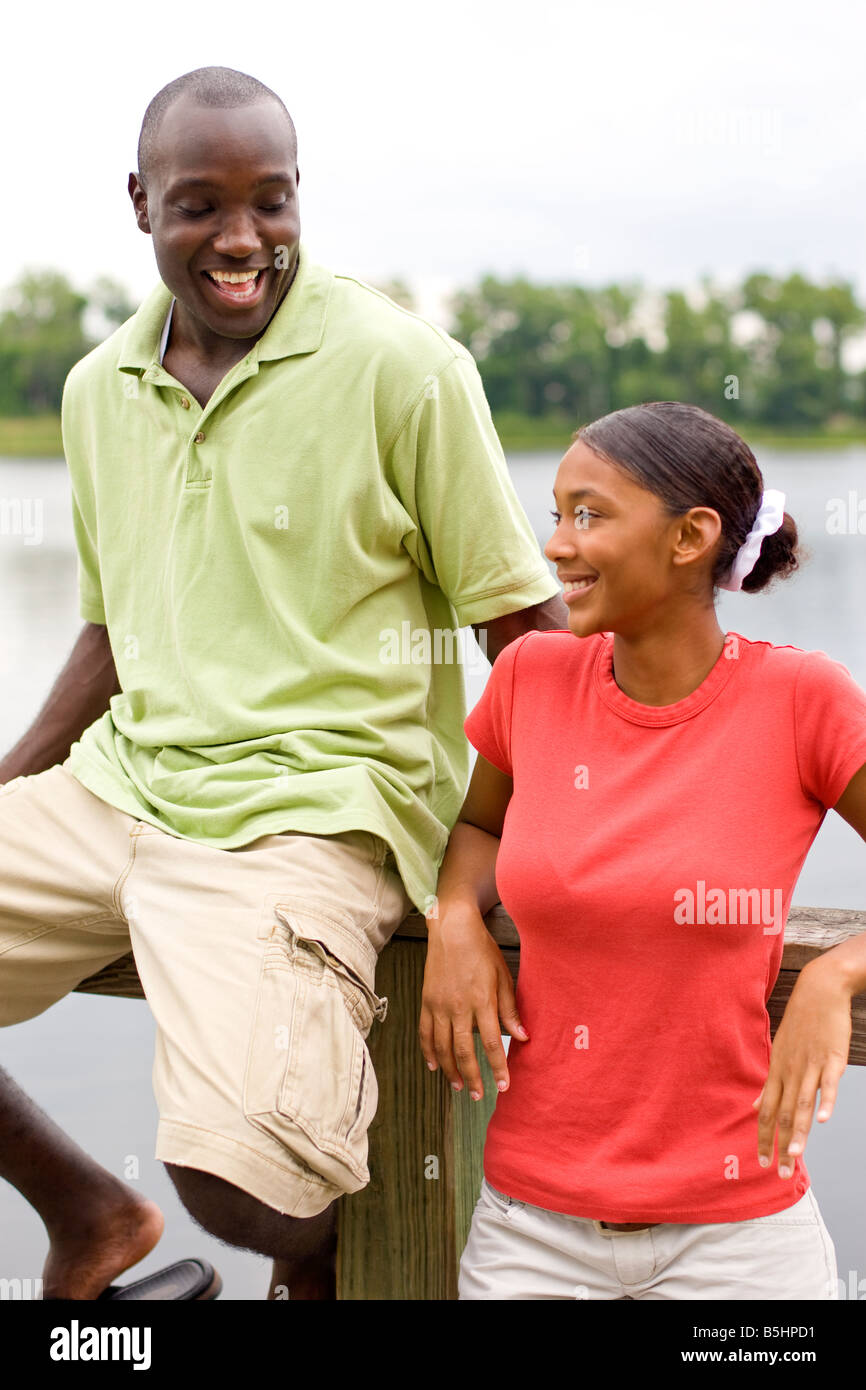 Two young people a man and a woman hang out on a dock in Orlando ...