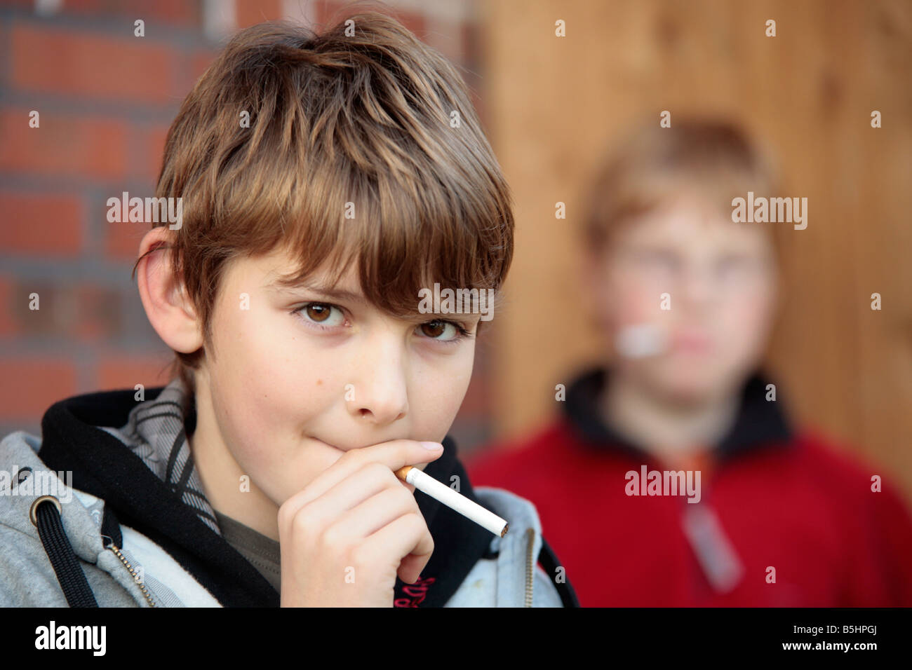 portrait of two underage boys smoking Stock Photo - Alamy