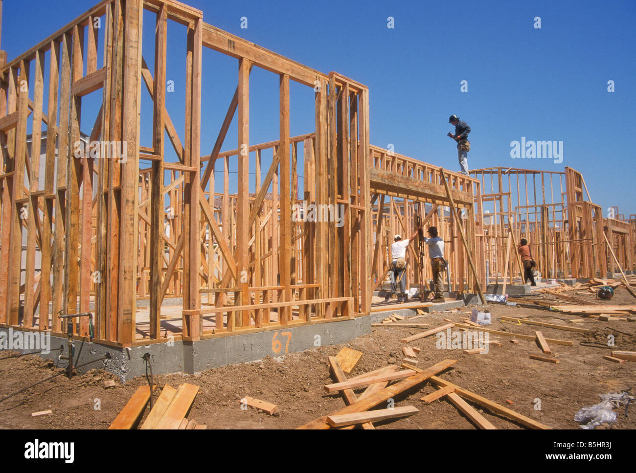 Homes being built in framing stage of construction Stock Photo - Alamy