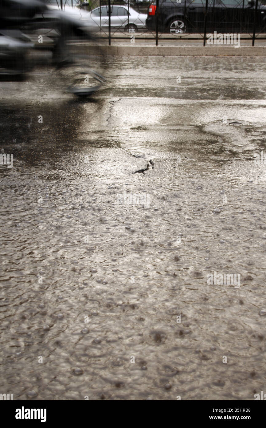 lots rain drops falling in water puddle in street Stock Photo - Alamy