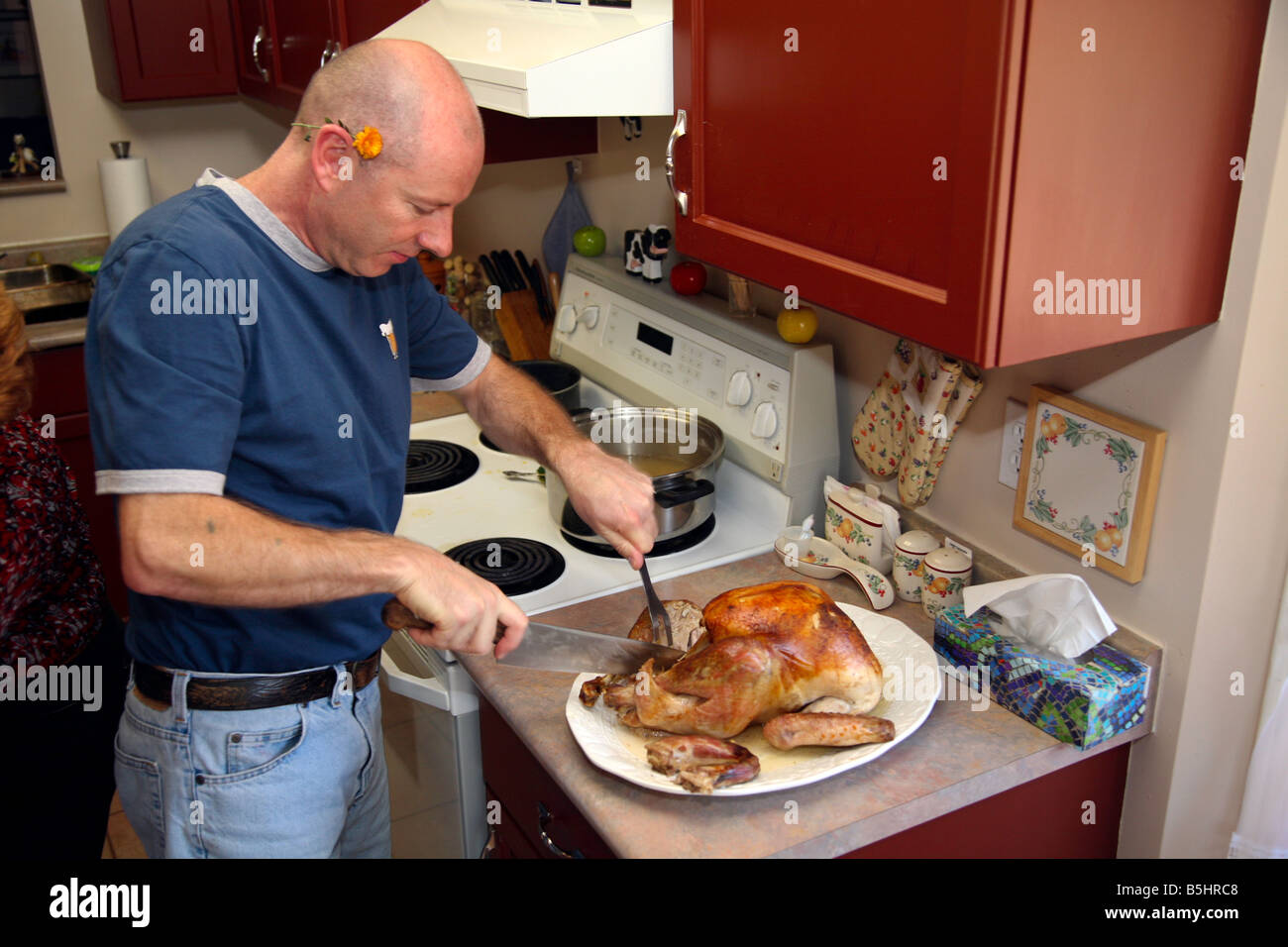 Man cutting the Turkey in the kitchen for the Celebration of ...