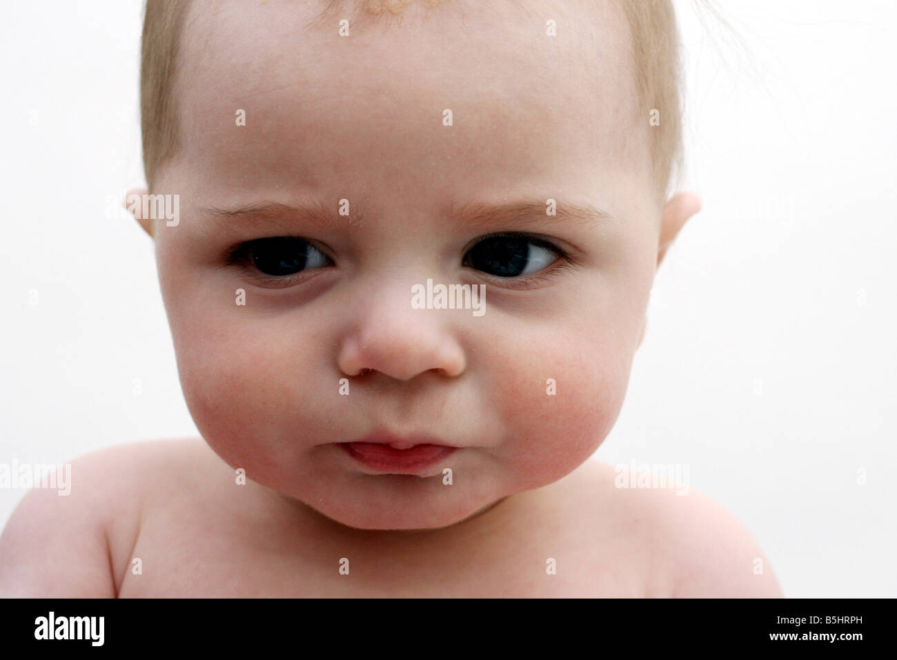 Cute baby boy smiling curiously hi-res stock photography and images - Alamy