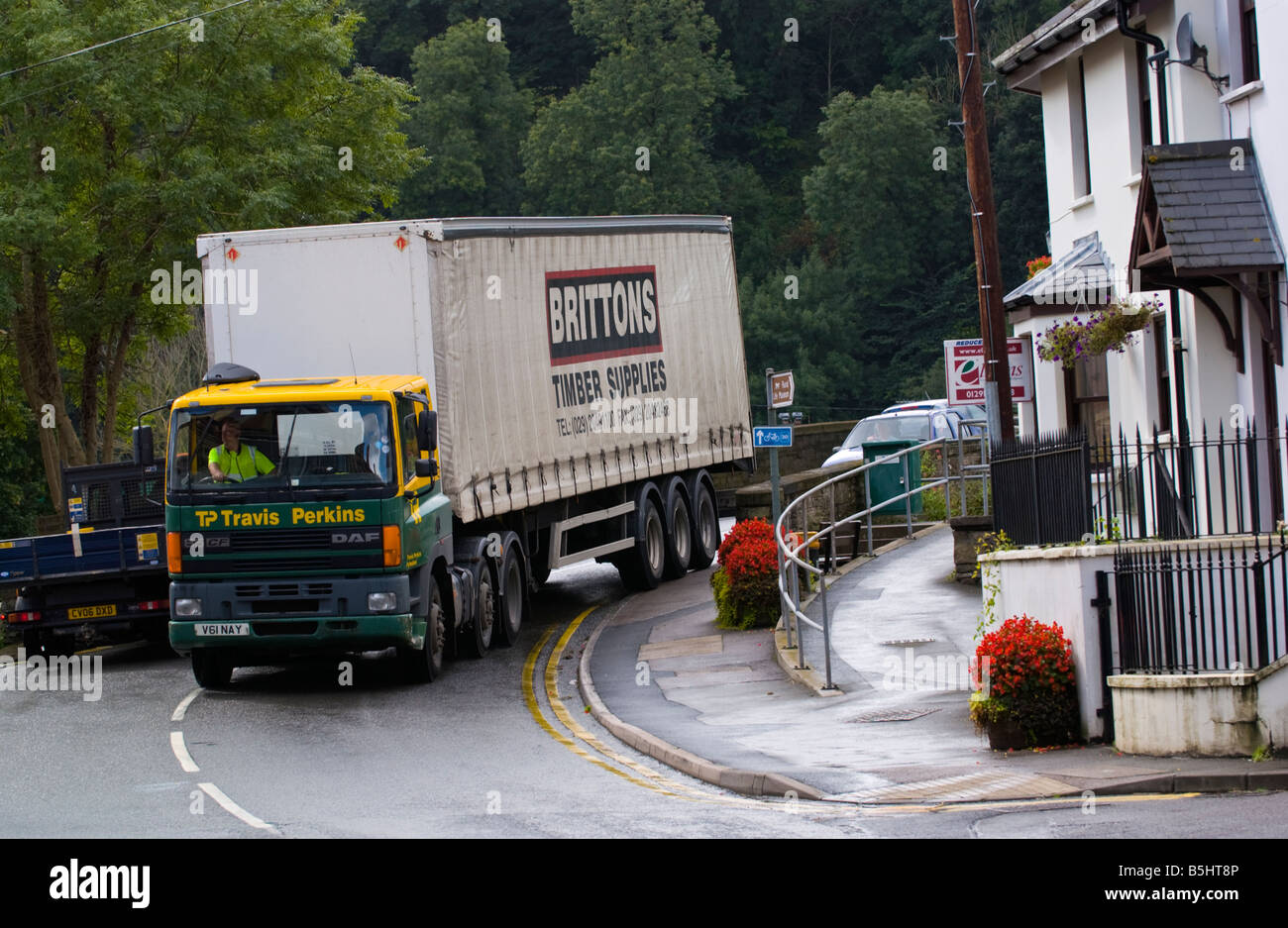 Heavy lorry crossing the river bridge in rural market town of Usk ...