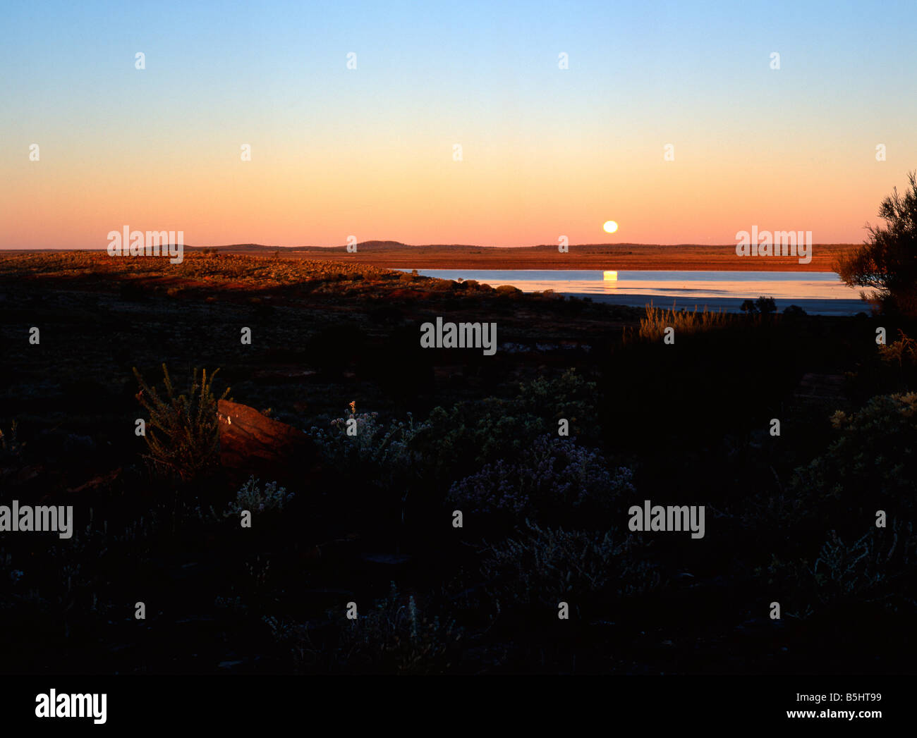 Full moon over lake at sunset, Murchison, Northwest Australia Stock ...