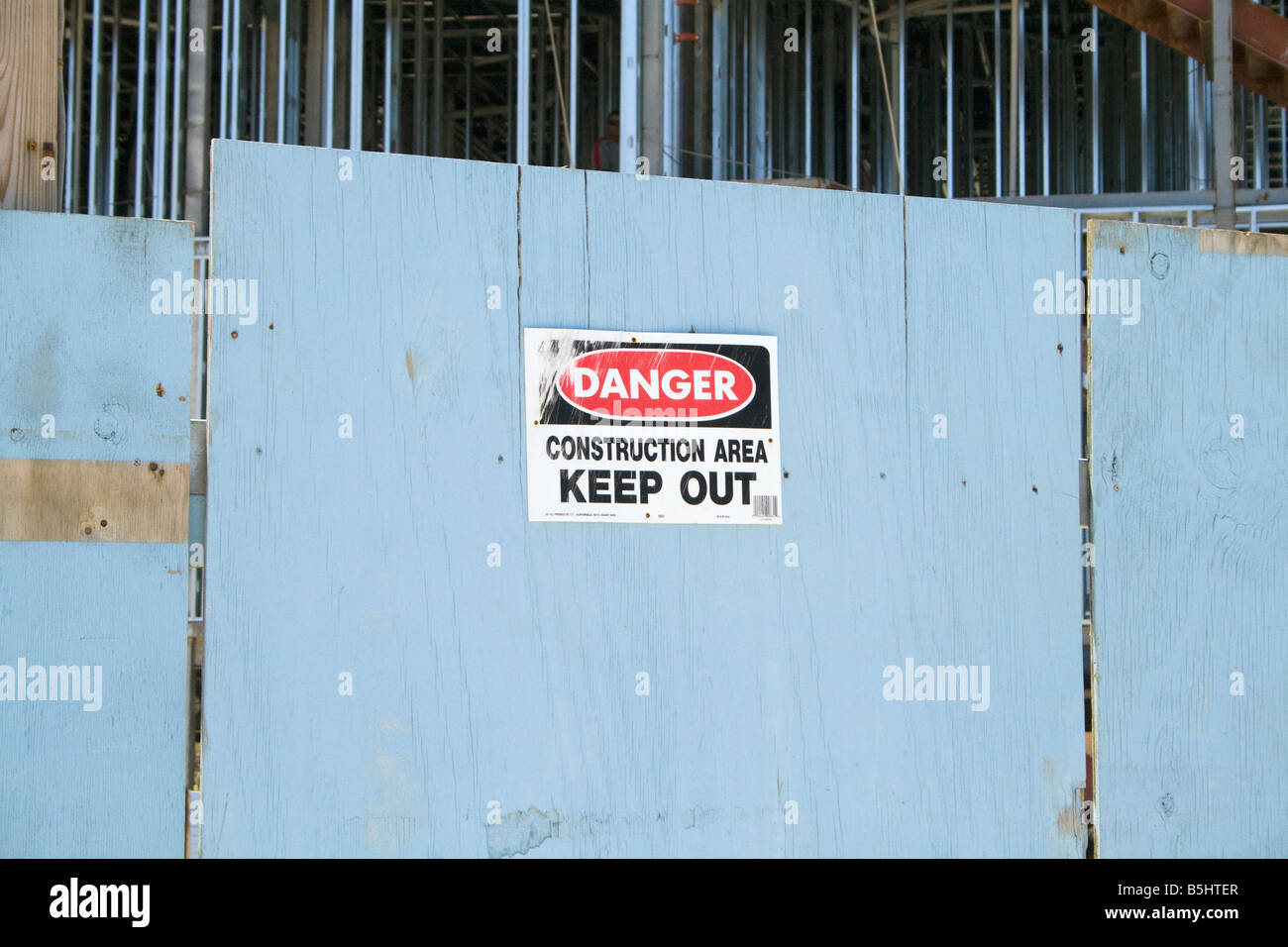 DANGER Construction Area Keep Out sign posted on plywood barrier in ...