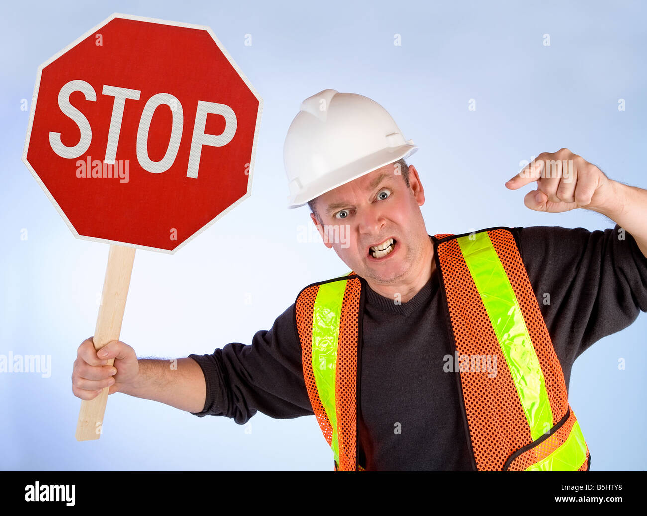 Road worker holding stop sign hi-res stock photography and images - Alamy