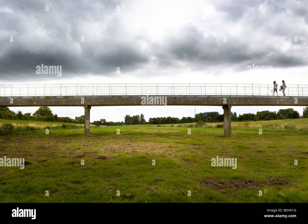 two women walking over bridge Stock Photo - Alamy