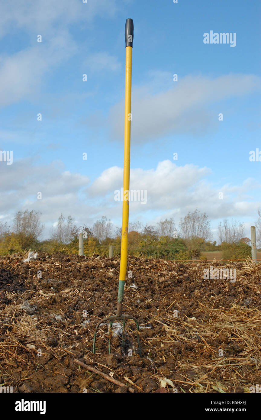 Fork in a muck heap Stock Photo - Alamy