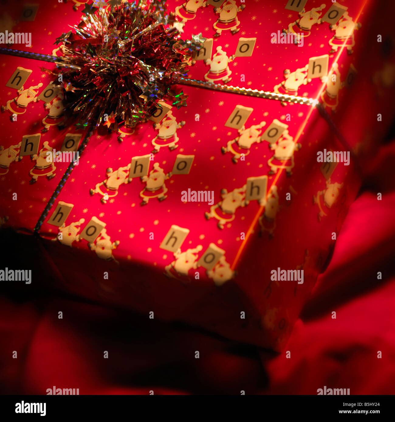 RED WRAPPED CHRISTMAS PRESENT ON RED VELVET Stock Photo - Alamy