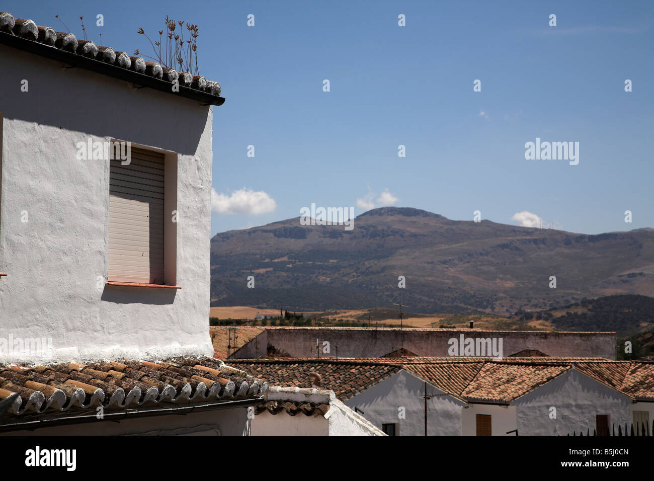 Spanish tiled rooftops looking towards mountain Stock Photo - Alamy