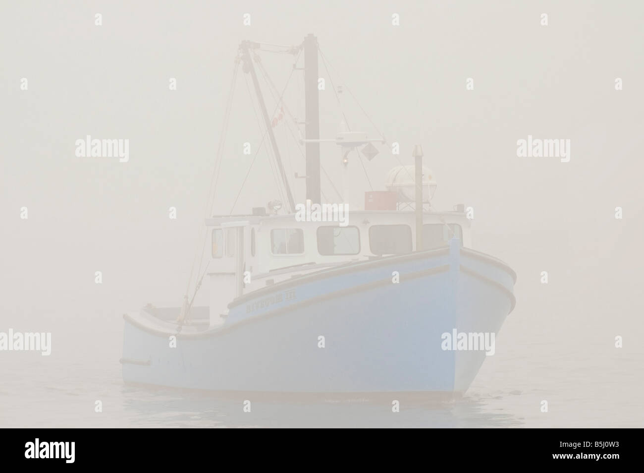 A fishing boat in the fog Stock Photo - Alamy