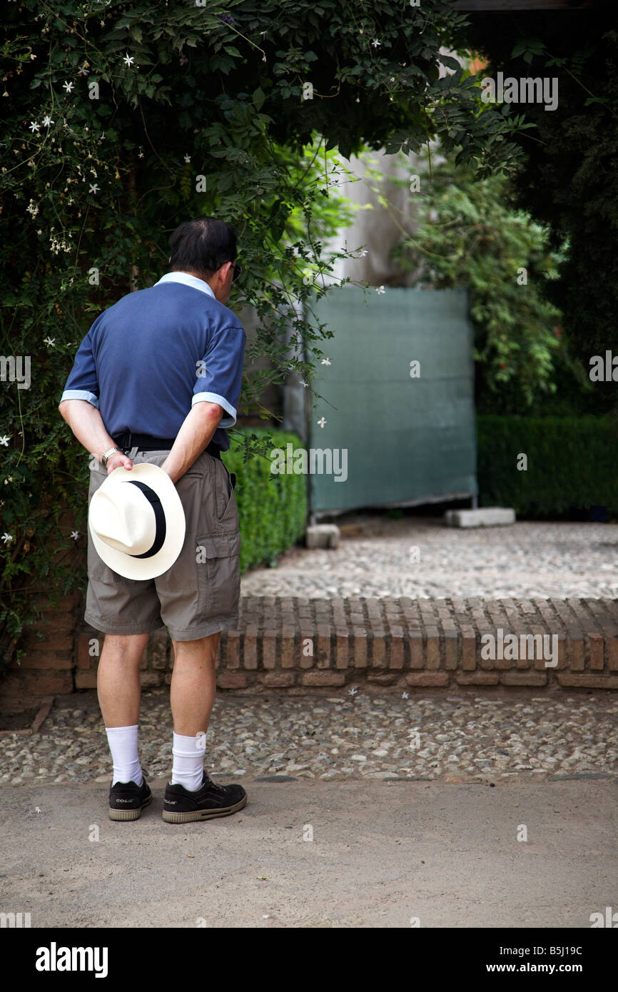 Man peering through archway Stock Photo - Alamy