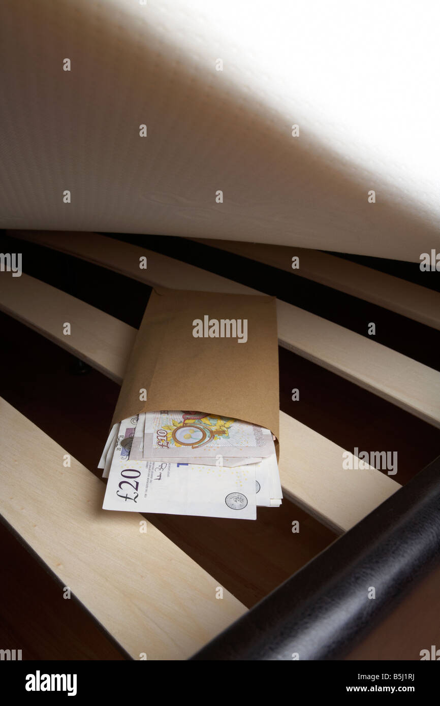 wad of 20 and 10 pounds sterling bank of england cash in an envelope ...