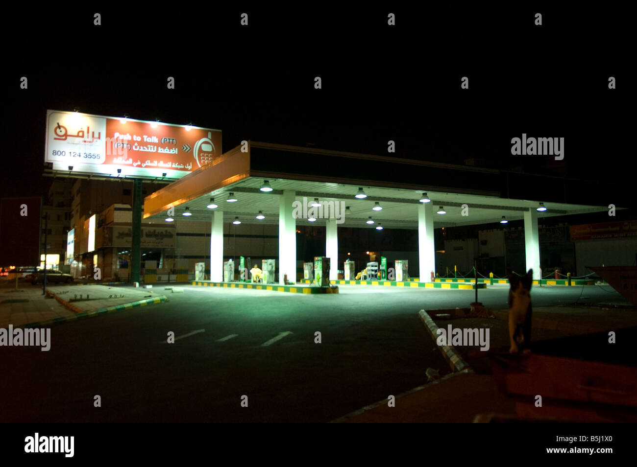 Saudi Arabian Petrol station at night illuminated with canopy lighting ...