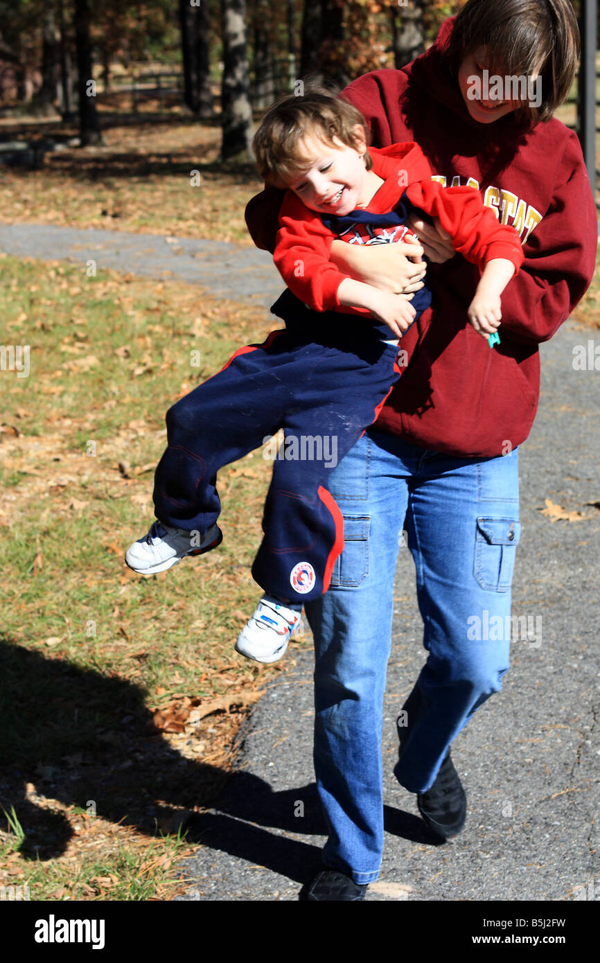 Mother Carrying Child Stock Photo - Alamy