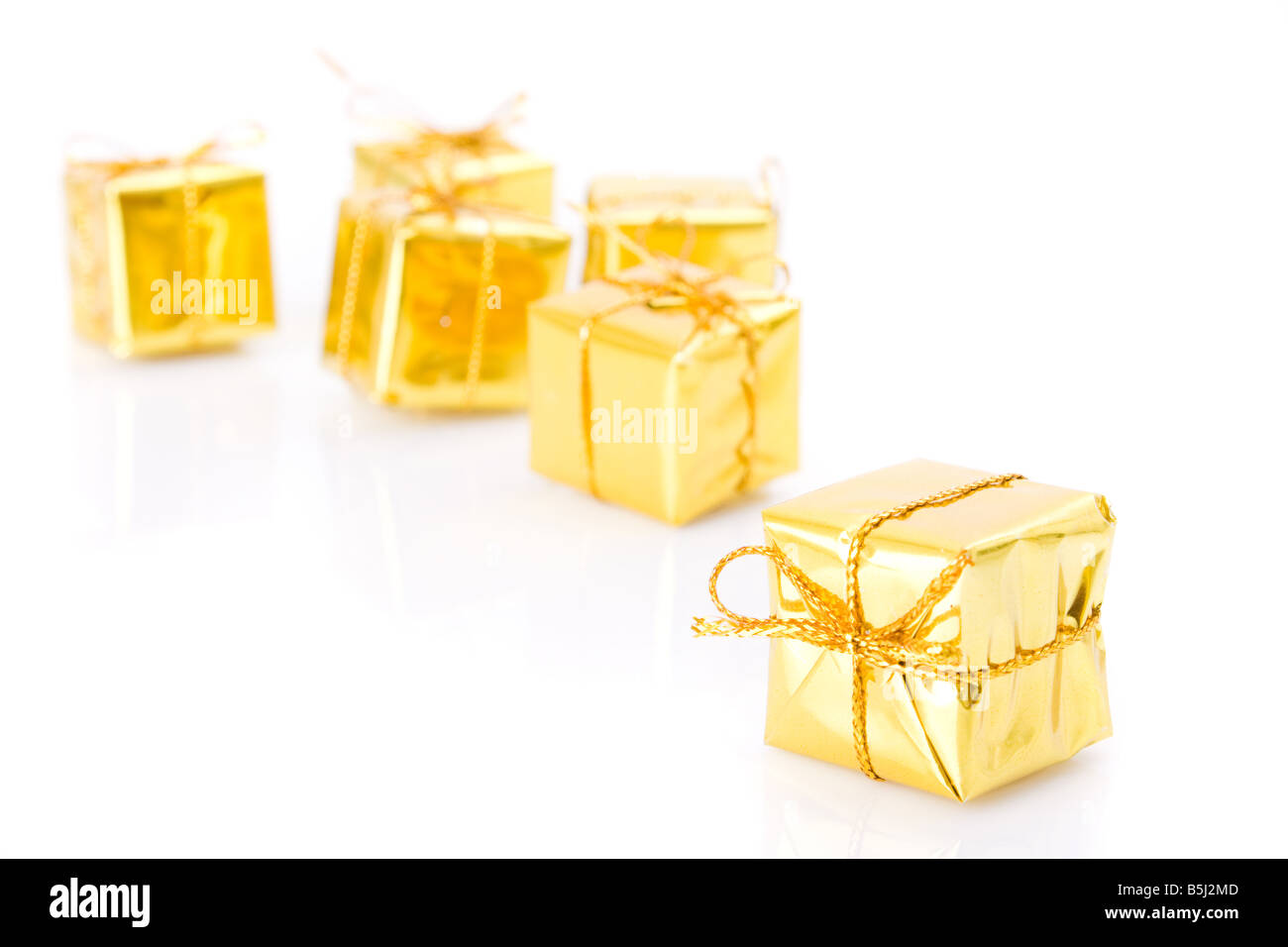 Small golden gifts isolated on white background Stock Photo - Alamy