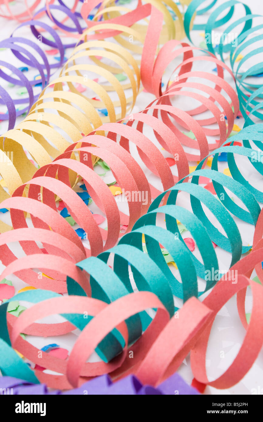 Several colourful party paper ribbons and confetti Stock Photo - Alamy