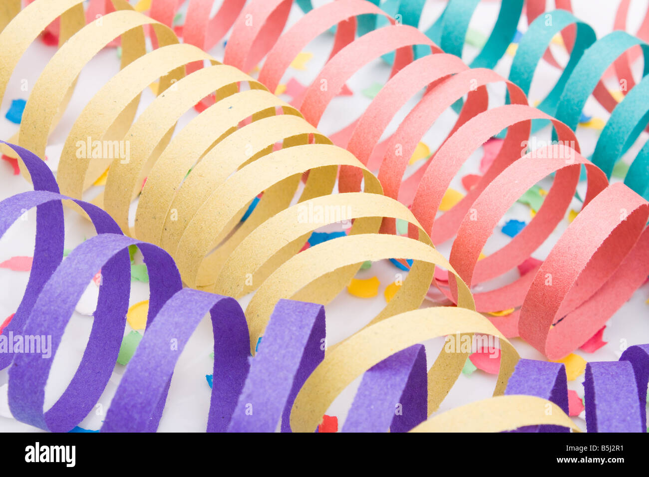 Several colourful party paper ribbons and confetti Stock Photo - Alamy