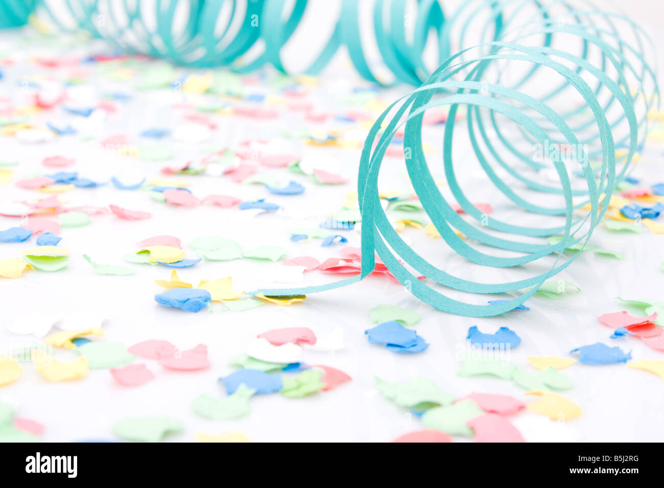 Several colourful party paper ribbons and confetti Stock Photo - Alamy