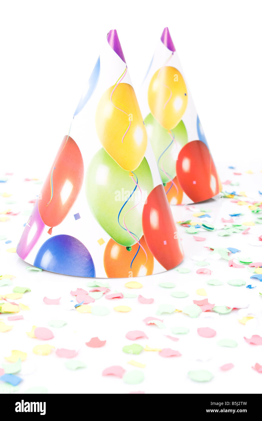 Party hats and confetti on white background Stock Photo - Alamy