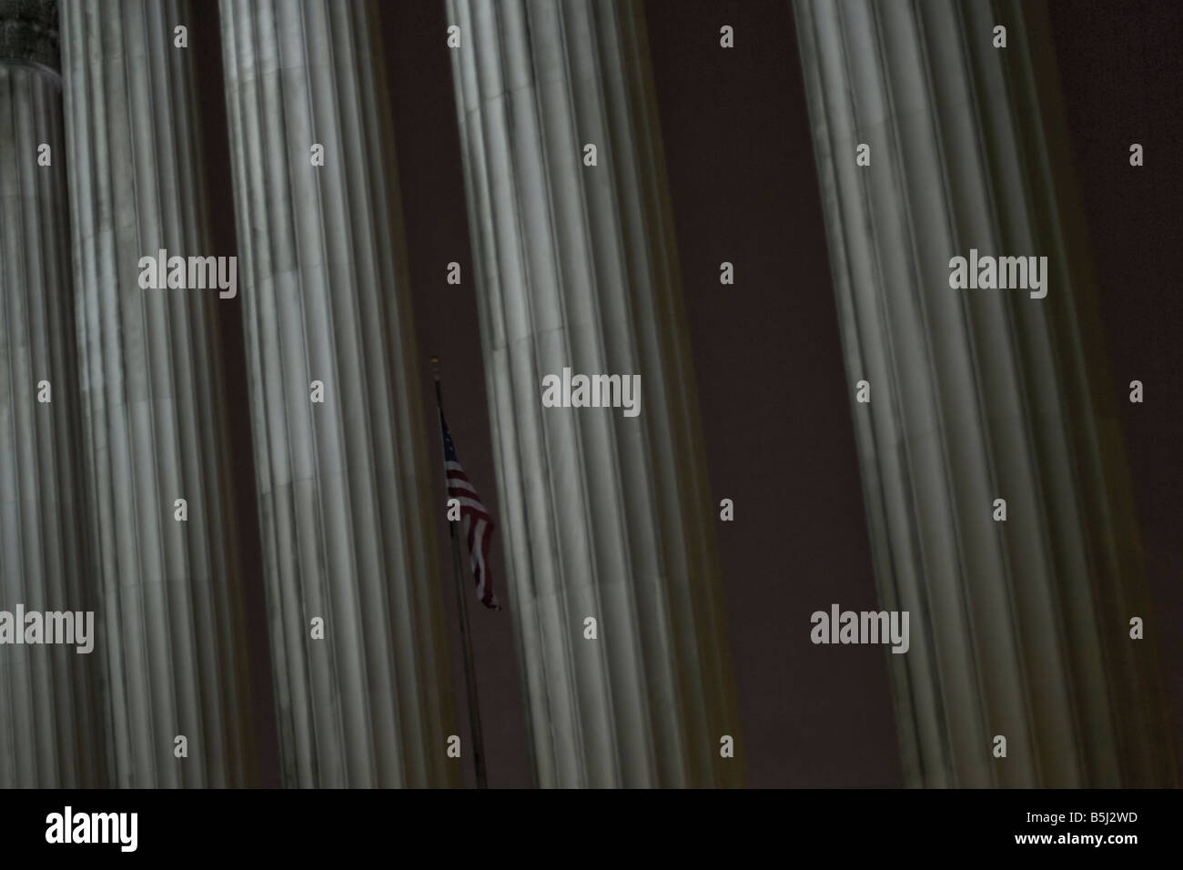 US flag among columns Stock Photo - Alamy