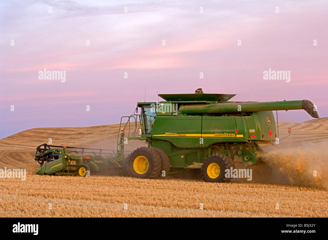 Combine harvesting wheat hill sunset hi-res stock photography and ...