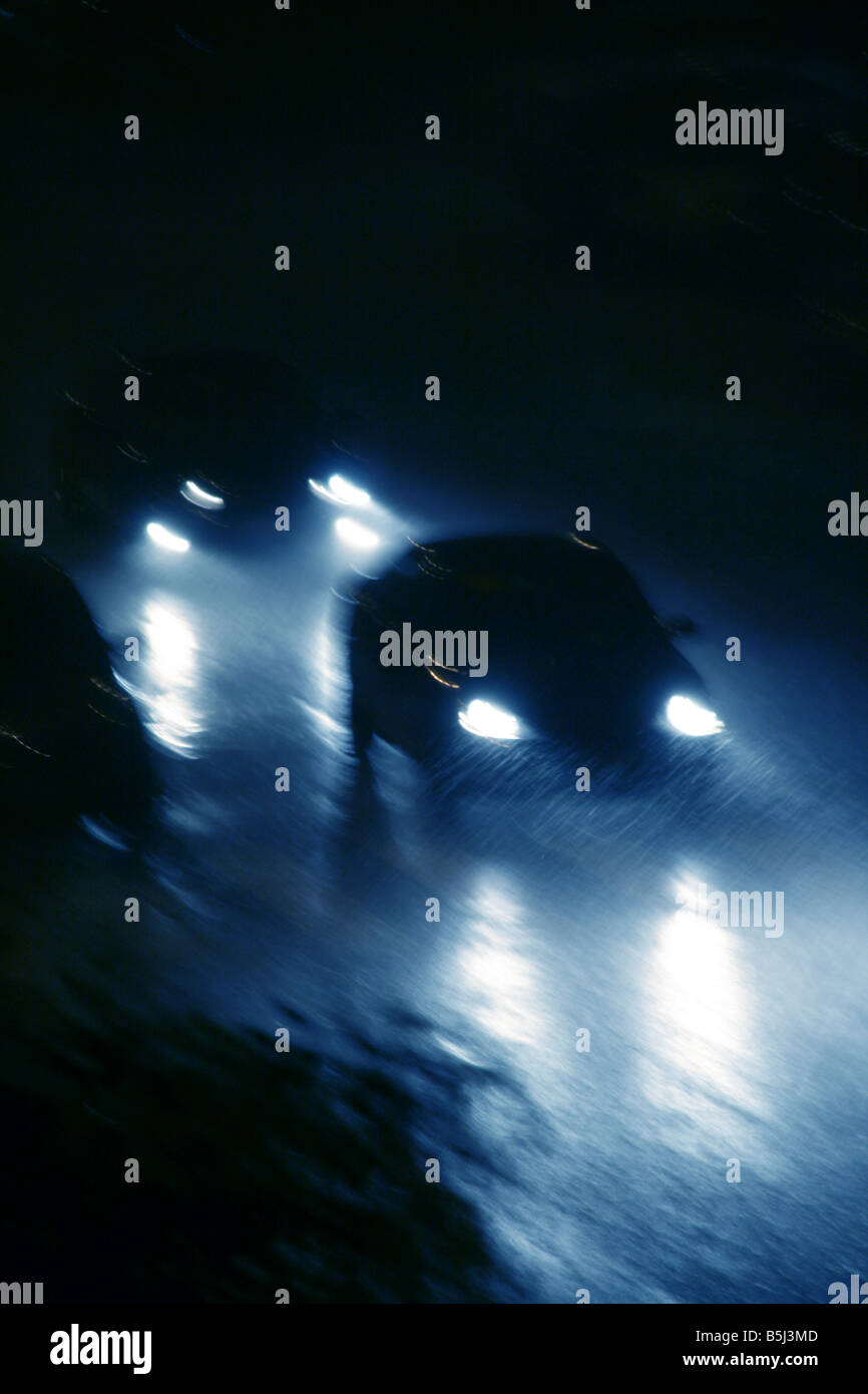 fast cars driving in heavy rain at night in town Stock Photo - Alamy