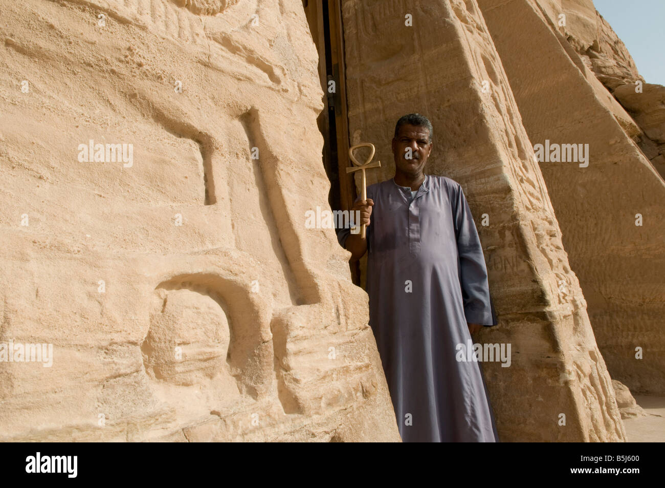 A guard holds an object in shape of ancient Egyptian hieroglyph symbol ...