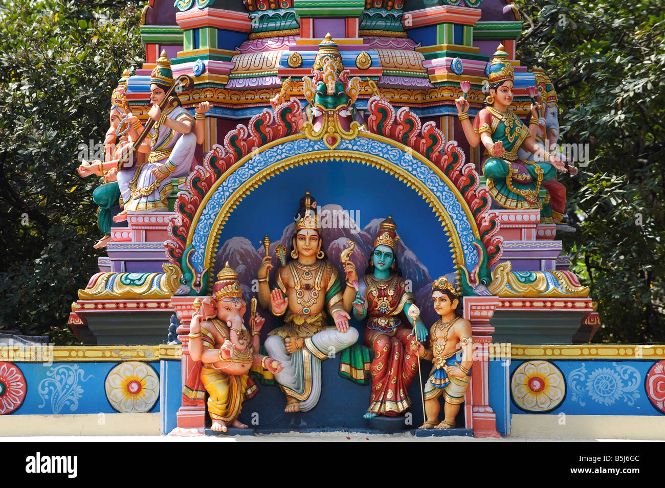 Hindu deities, sculpted painted statues, on a hindu temple in Banglore ...