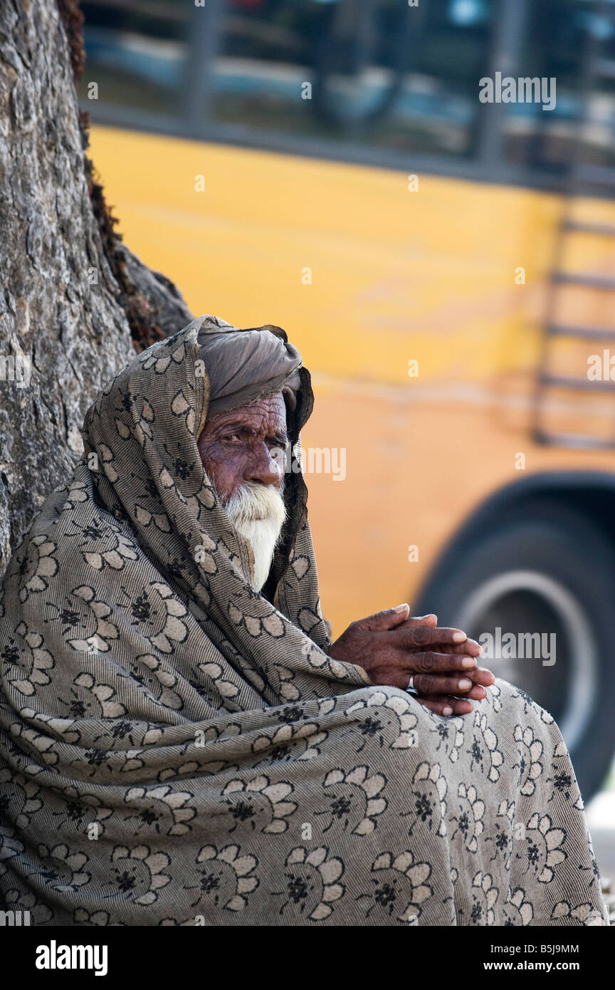 Old indian man sitting against banyan tree. Chikballapur, Karnataka ...