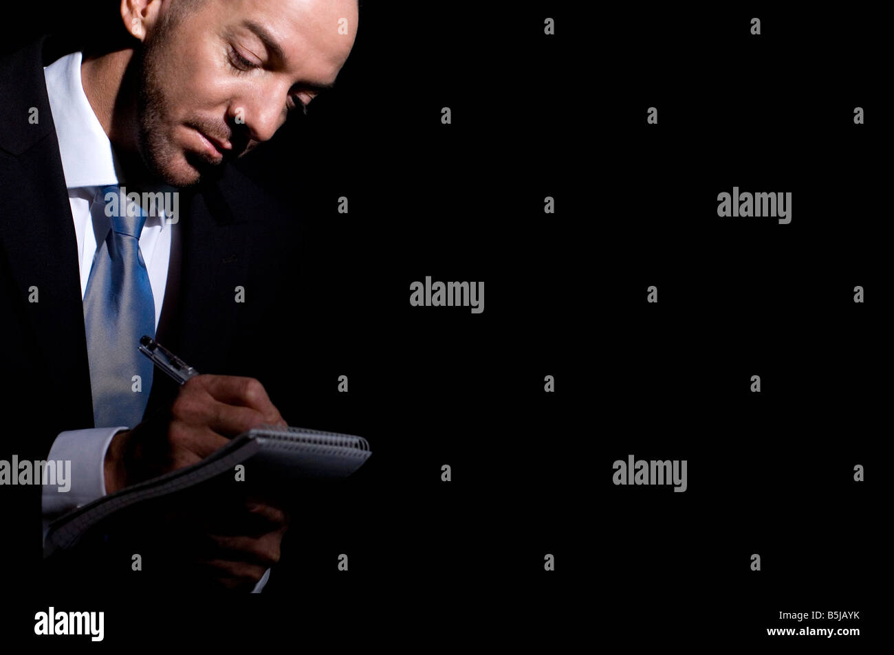 portrait of businessman with pen and writing pad Stock Photo - Alamy