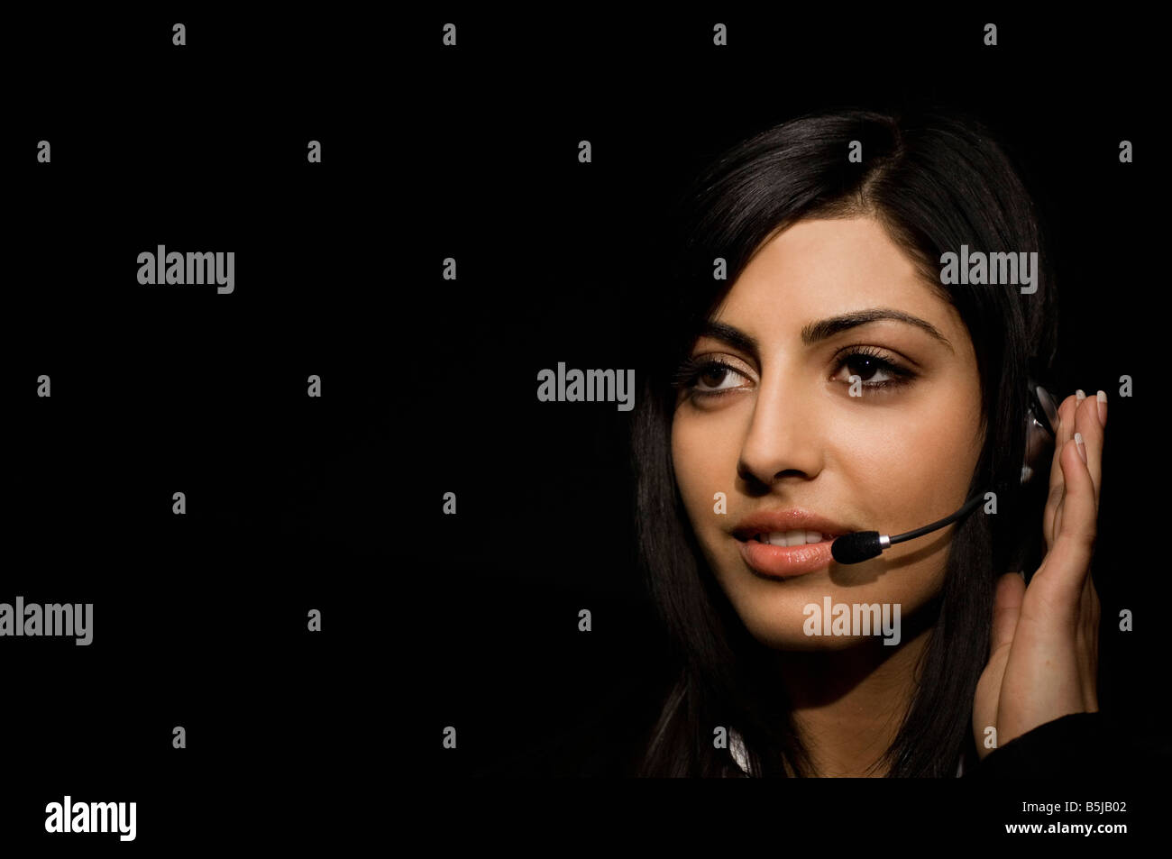 headshot of young woman wearing headset Stock Photo - Alamy