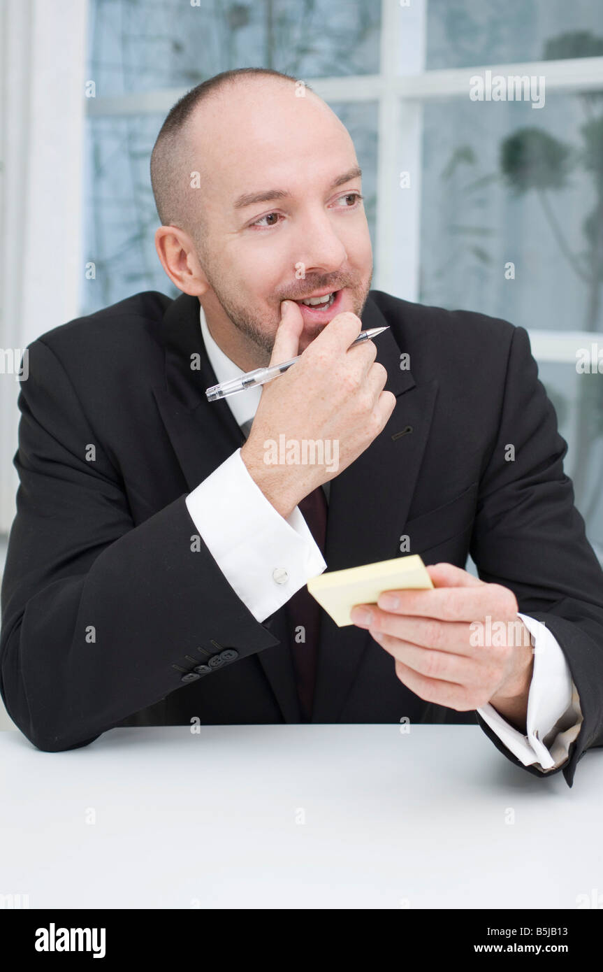 portrait of businessman holding post-its Stock Photo - Alamy
