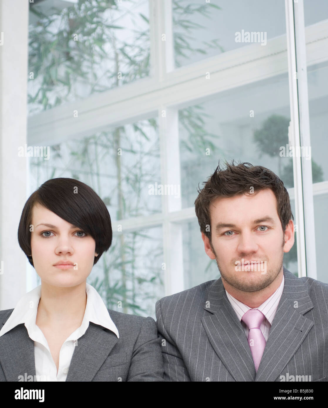 portrait of two smiling business people Stock Photo - Alamy