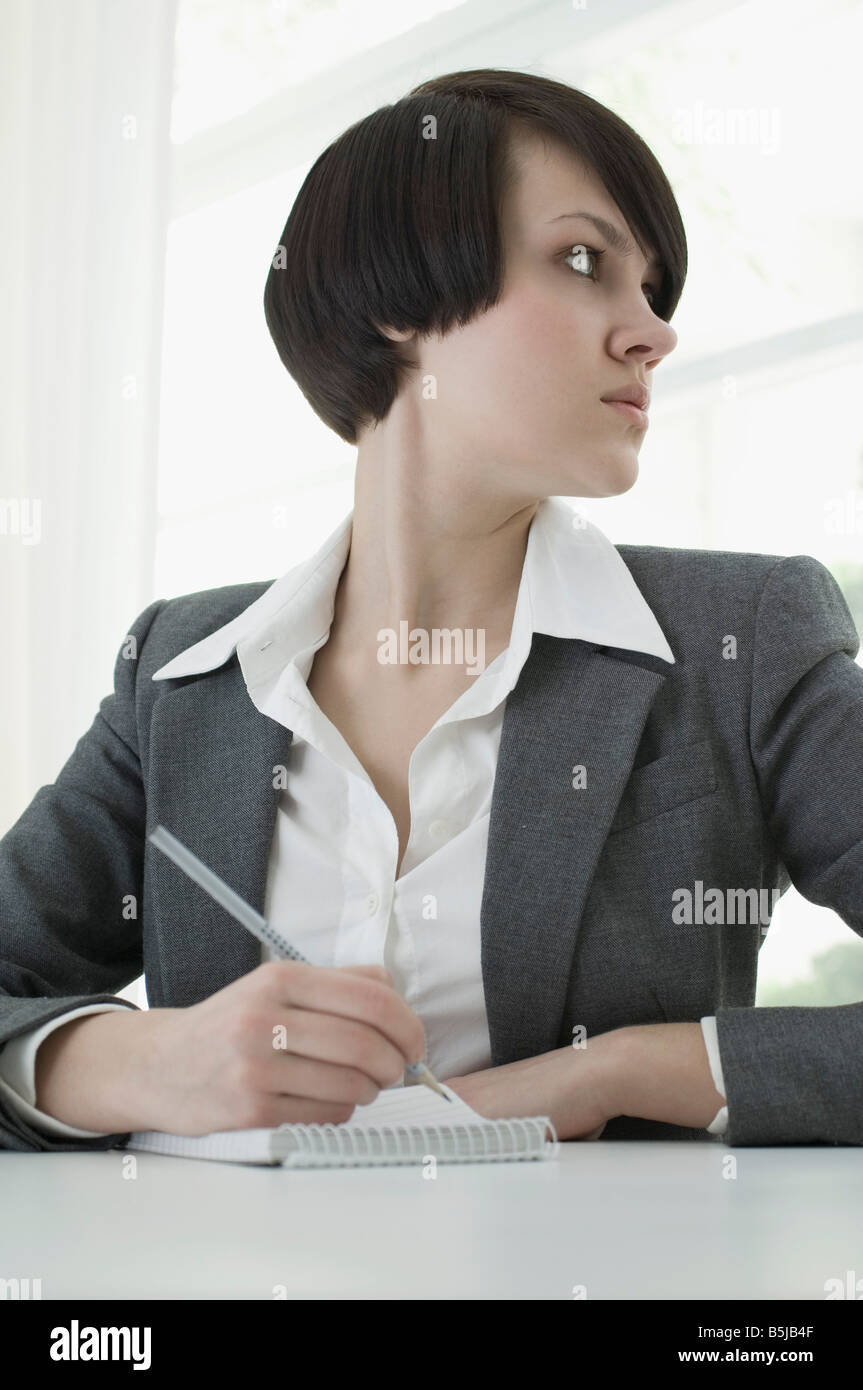 Portrait thinking woman taking note hi-res stock photography and images ...