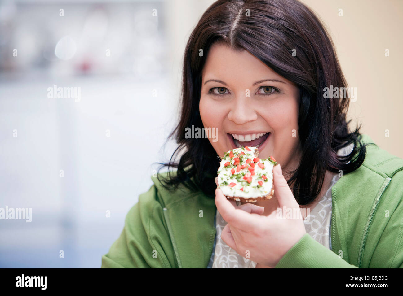 headshot of overweight woman eating bread with cream cheese Stock Photo ...