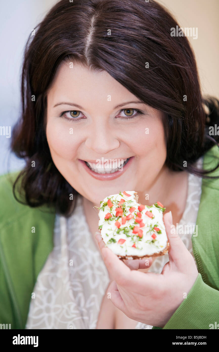 headshot of overweight woman eating bread with cream cheese Stock Photo ...
