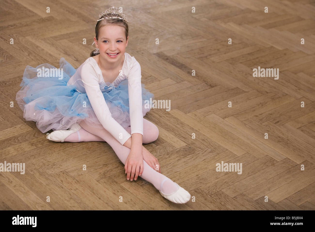 portrait of young ballet dancer sitting on floor Stock Photo - Alamy