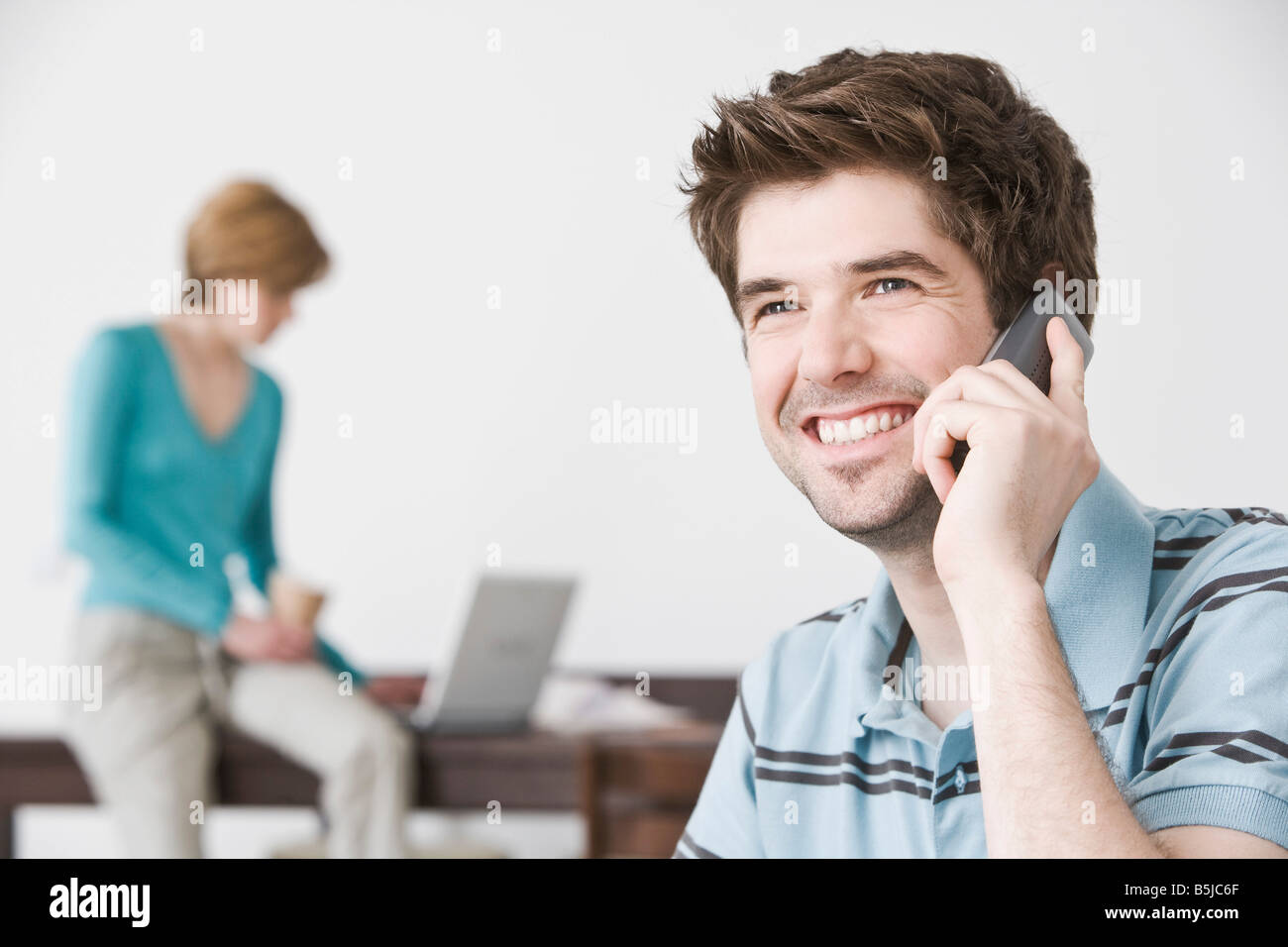 portrait of young man at home talking on the telephone Stock Photo - Alamy