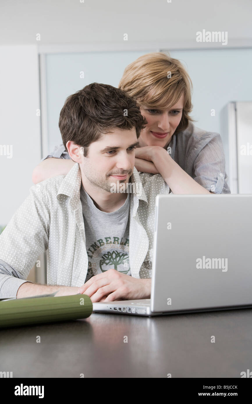 portrait sitting at home looking at laptop computer Stock Photo - Alamy