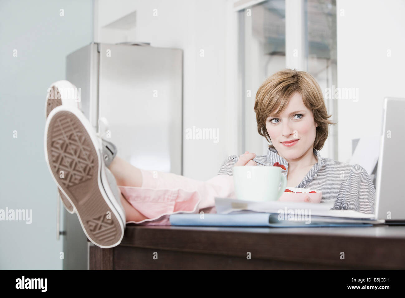 woman relaxing at home with feet on the table Stock Photo - Alamy