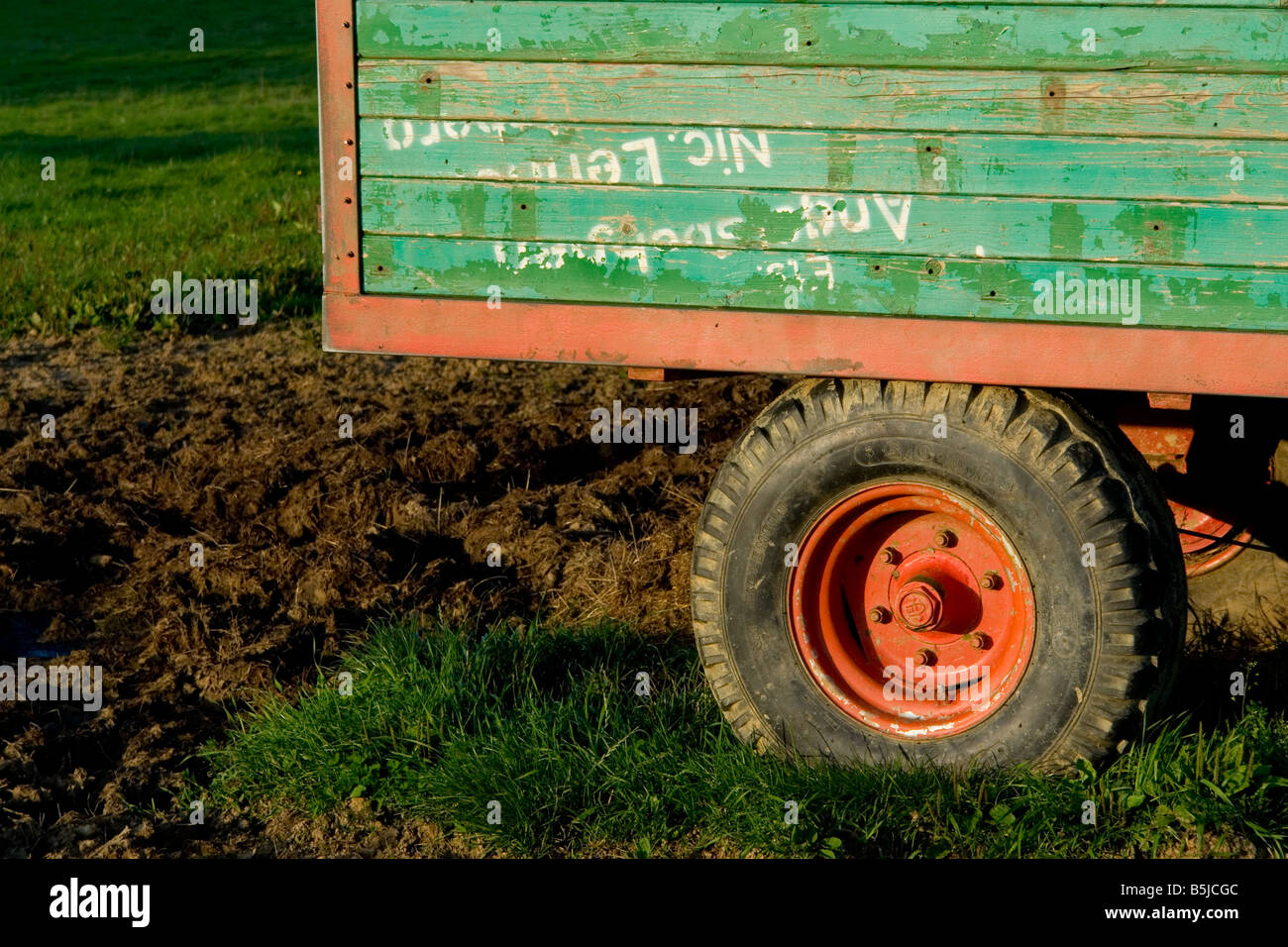 Green wooden cart in the field Stock Photo - Alamy