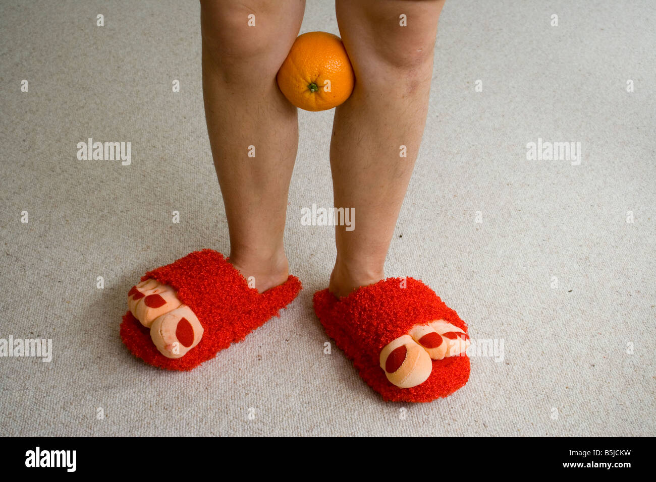 Red slippers with an orange Stock Photo - Alamy