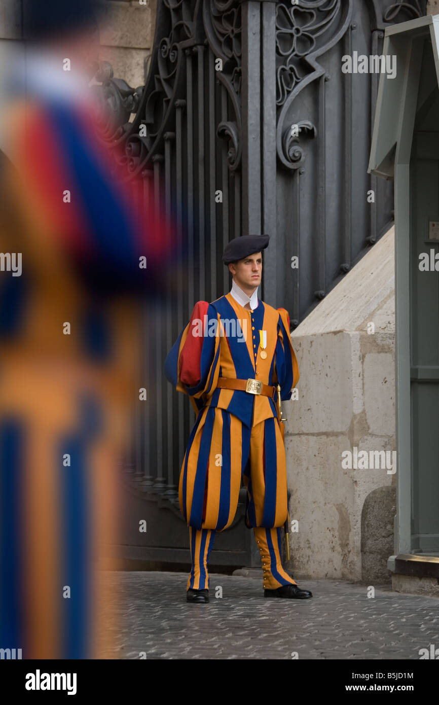 Two Papal Swiss Guards stand guard in traditional uniform with pike in ...