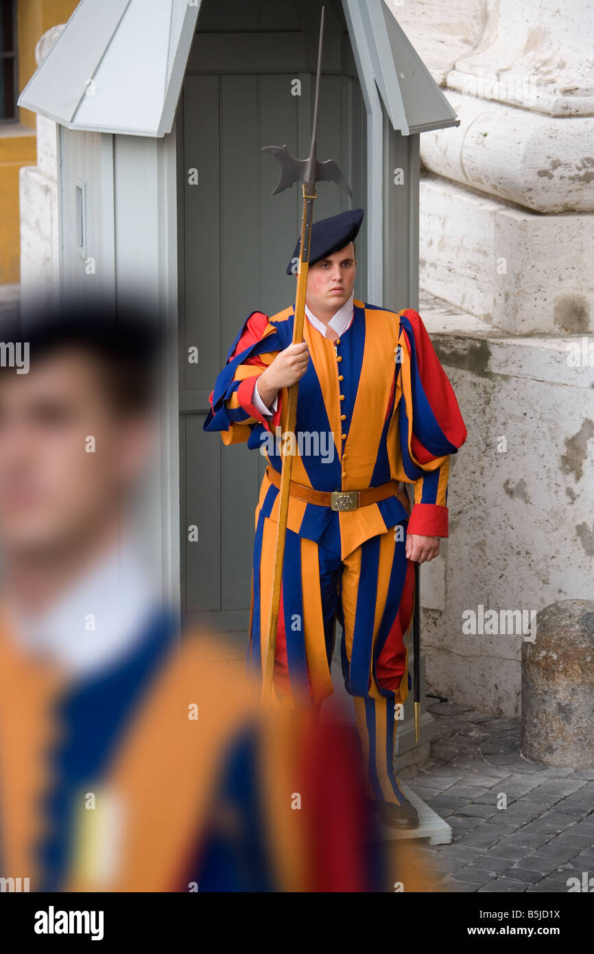 Two Papal Swiss Guards stand guard in traditional uniform with pike in ...