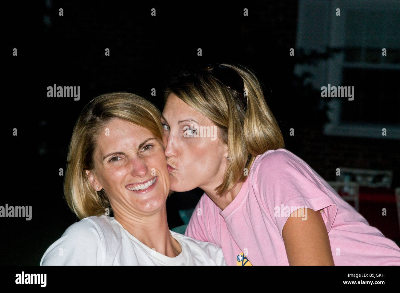 Twin sisters kid around at family picnic gathering Stock Photo - Alamy