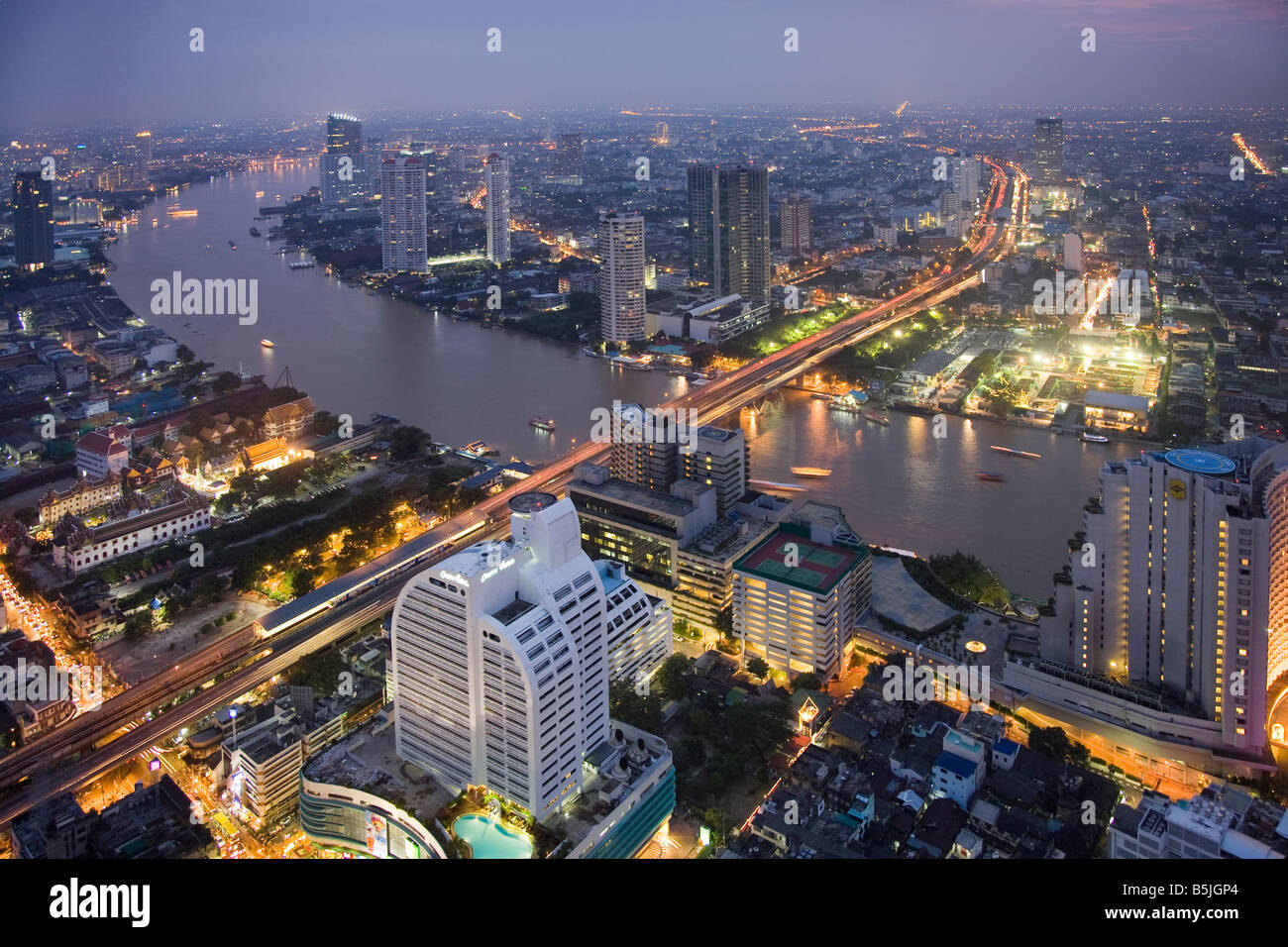 Aerial view of the City of Bangkok at dusk, High-rise buildings, roads ...