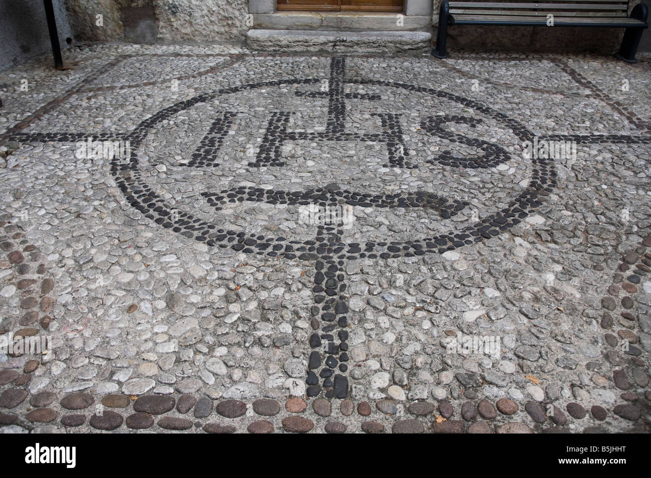 Religious letters on cabblestoned church front entrance, Malcesine ...